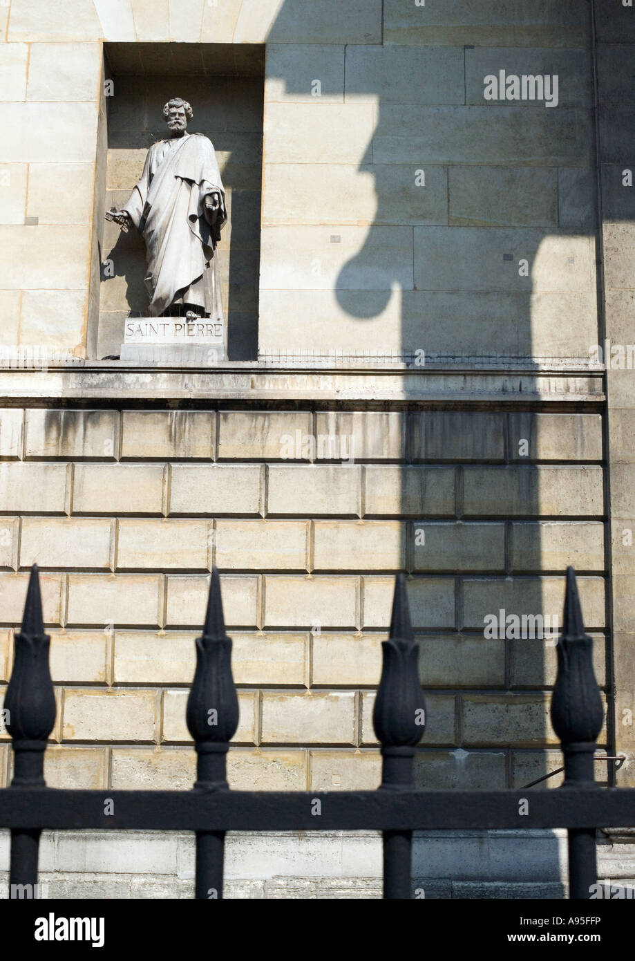 Statue of St. Peter in wall alcove, iron gate in foreground Stock Photo ...
