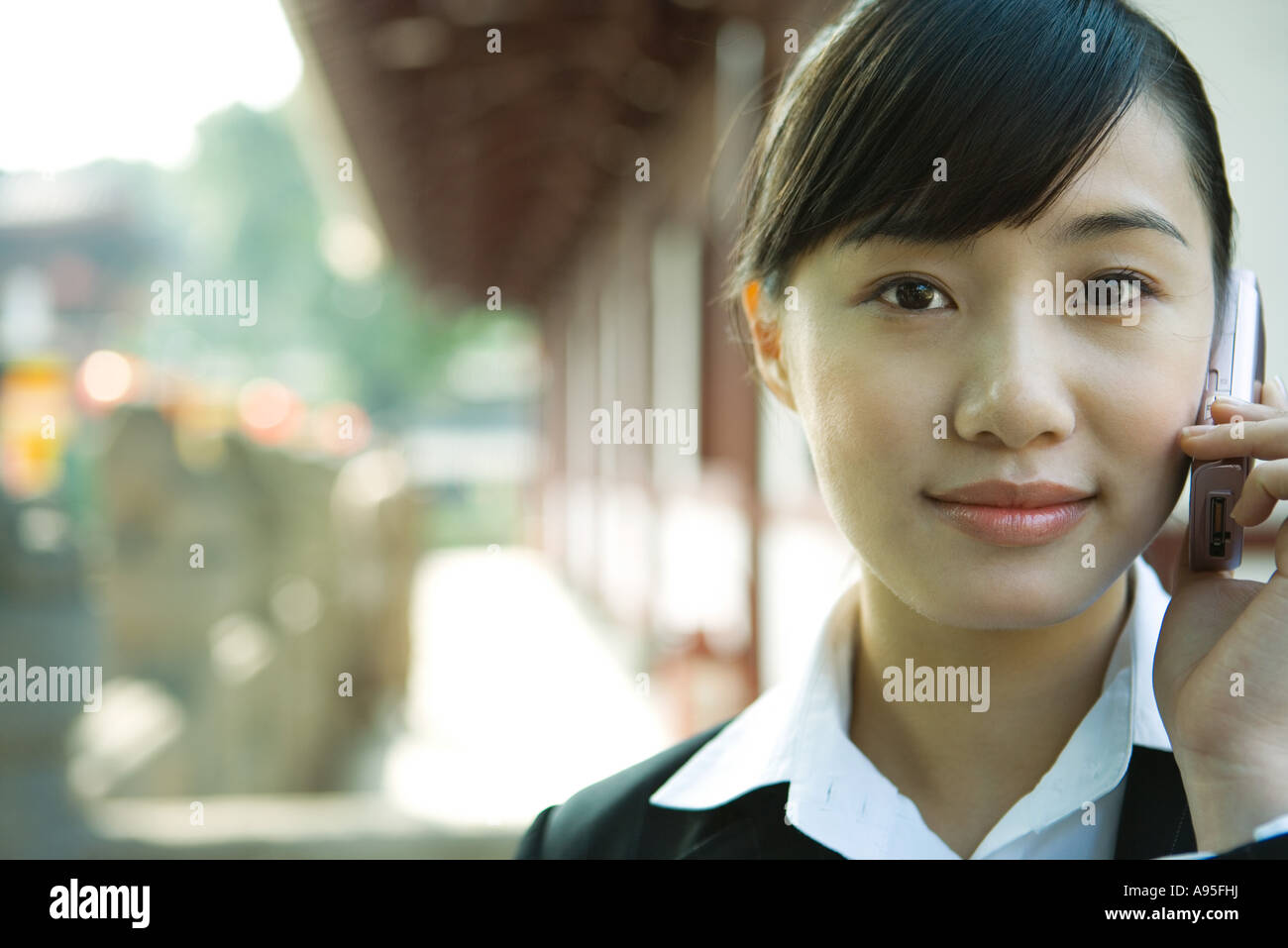 Young woman using cell phone, close-up Stock Photo - Alamy