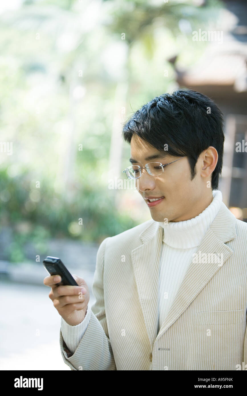 Young man using cell phone Stock Photo - Alamy