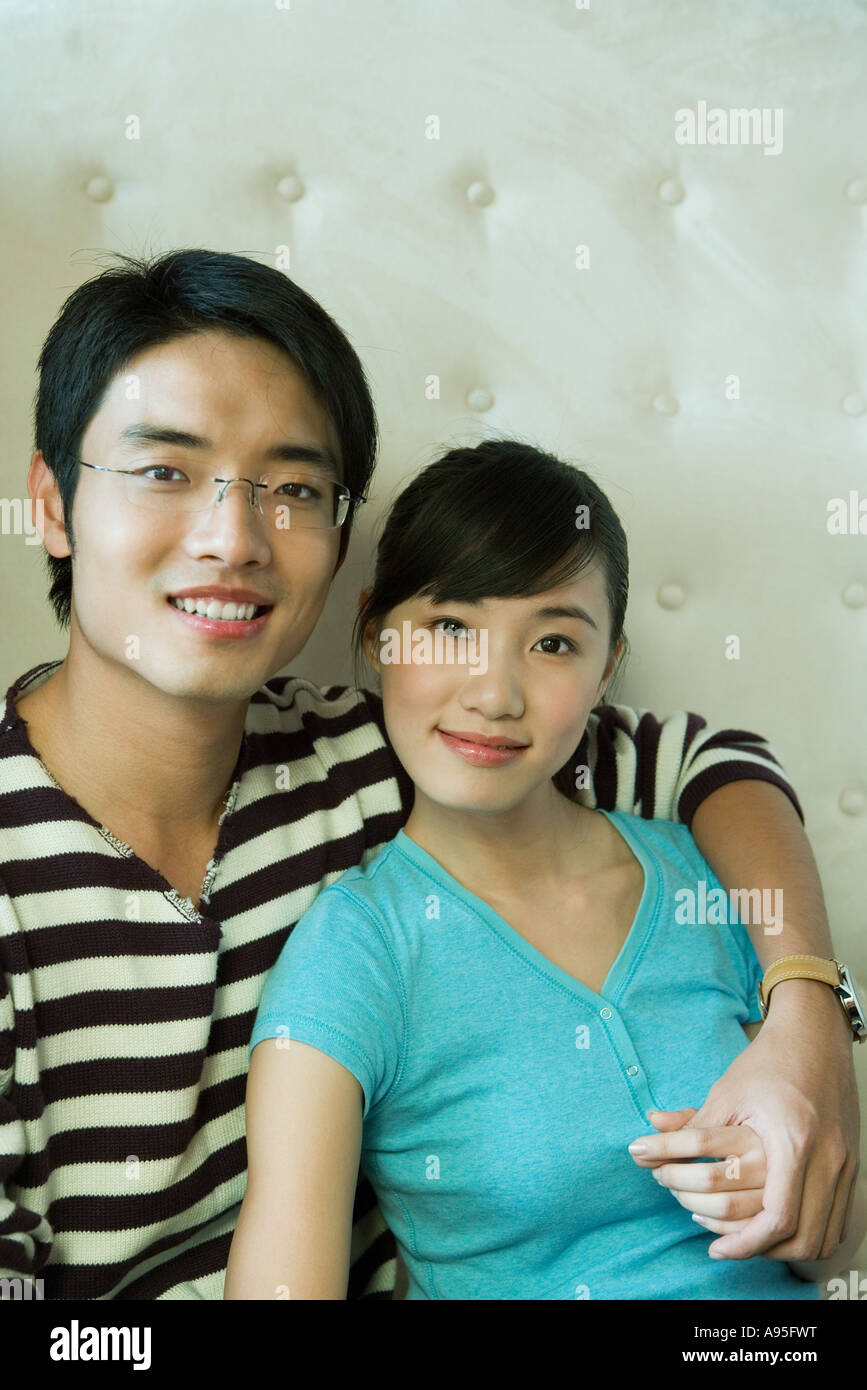 Young couple, man's arm around woman, portrait Stock Photo - Alamy