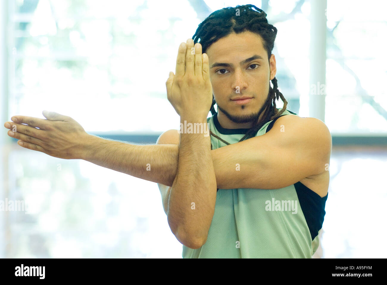 Man doing arm stretches Stock Photo - Alamy