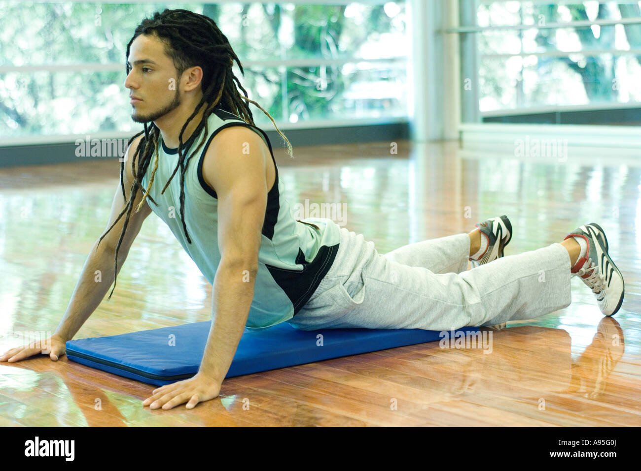 Man doing cobra pose, full length Stock Photo - Alamy