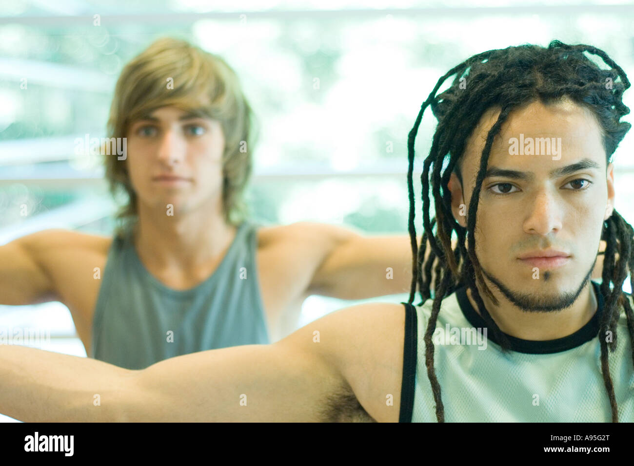 Young men with arms out in exercise class Stock Photo - Alamy