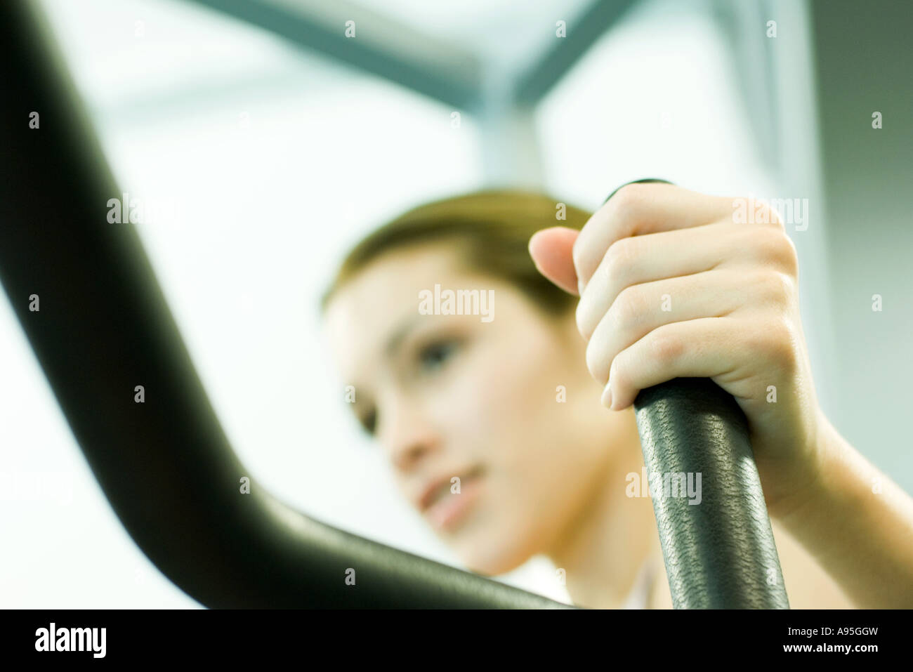 Woman using weight machine Stock Photo - Alamy