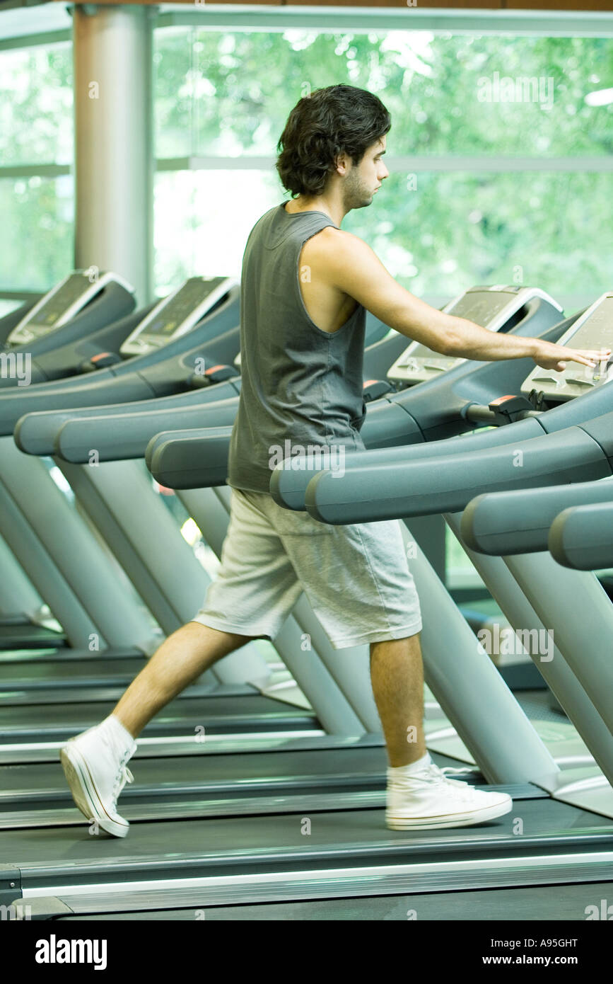 Man walking on treadmill Stock Photo - Alamy