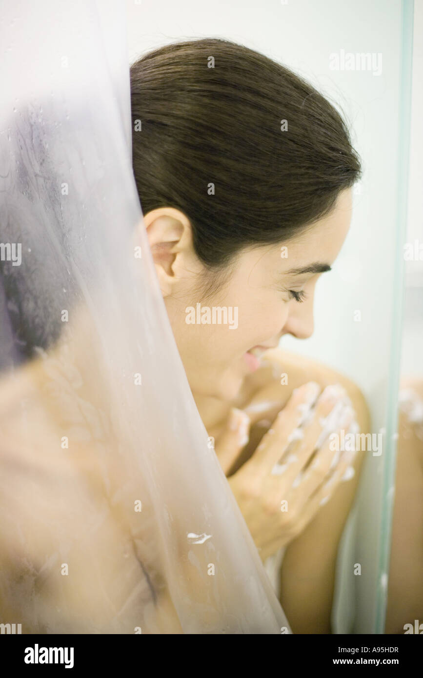 Woman in shower, washing shoulder Stock Photo - Alamy