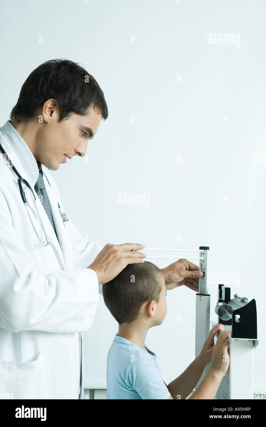 Doctor measuring boy during check-up Stock Photo - Alamy