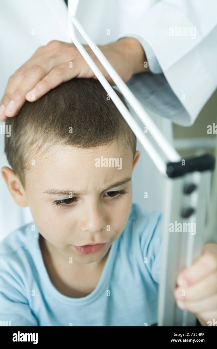 Doctor measuring boy during check-up Stock Photo - Alamy