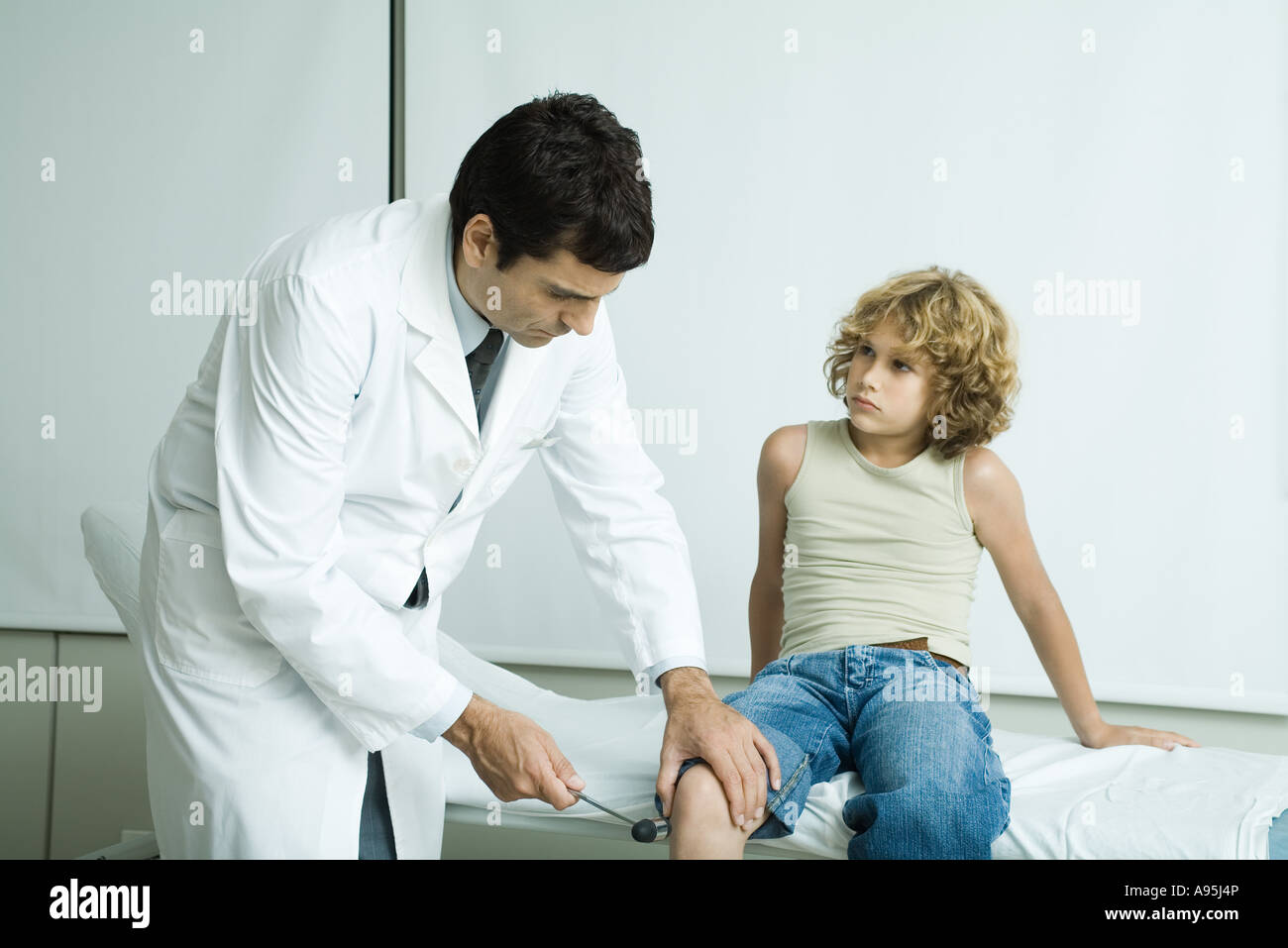 Doctor checking patients reflexes hi-res stock photography and images ...