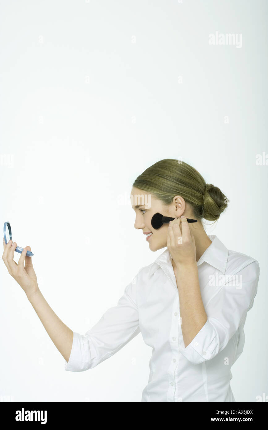 Teenage girl applying blush Stock Photo - Alamy