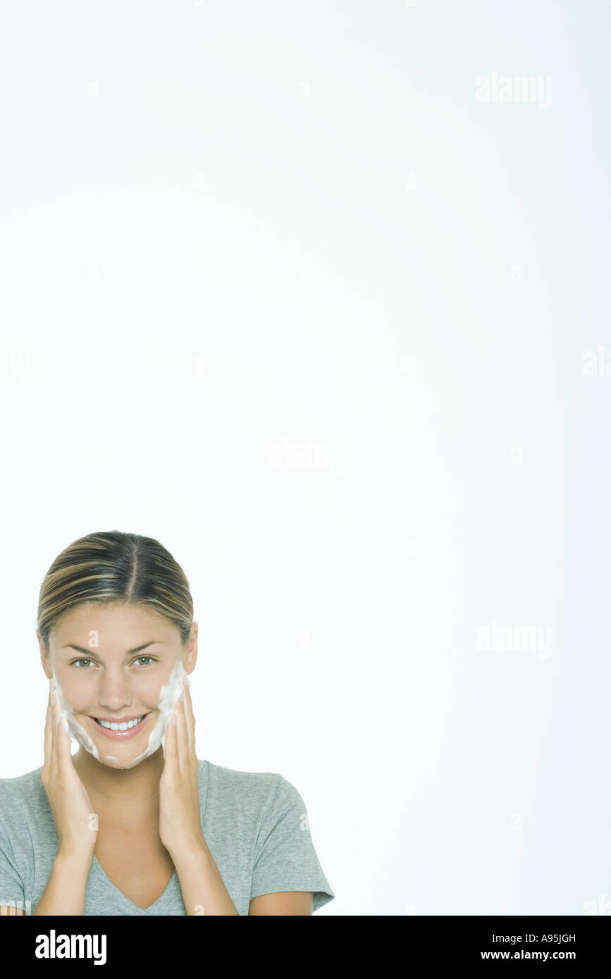 Woman washing face, smiling at camera Stock Photo - Alamy