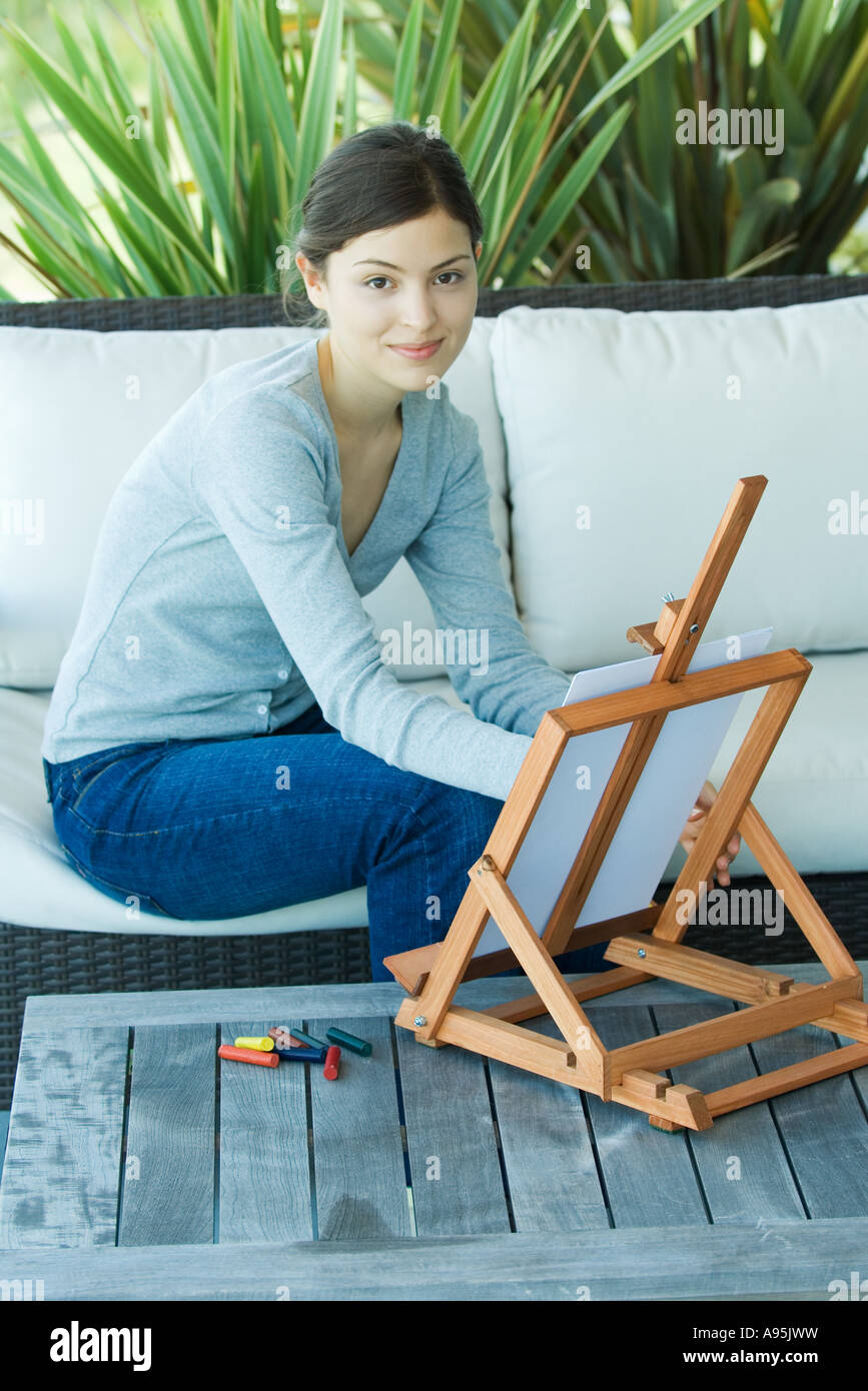 Young woman drawing with easel Stock Photo - Alamy