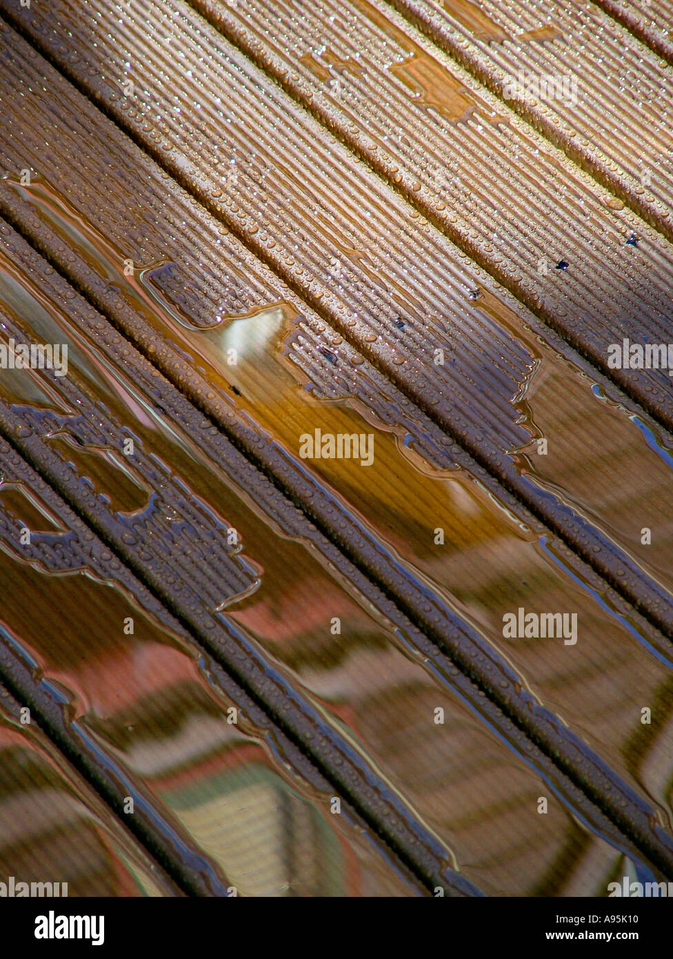 Water droplets on wood timber protection on decking Stock Photo - Alamy