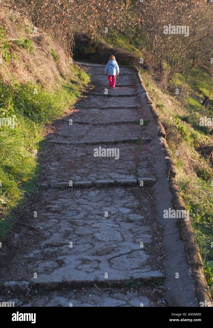 young girl walking up an old roman path Stock Photo - Alamy