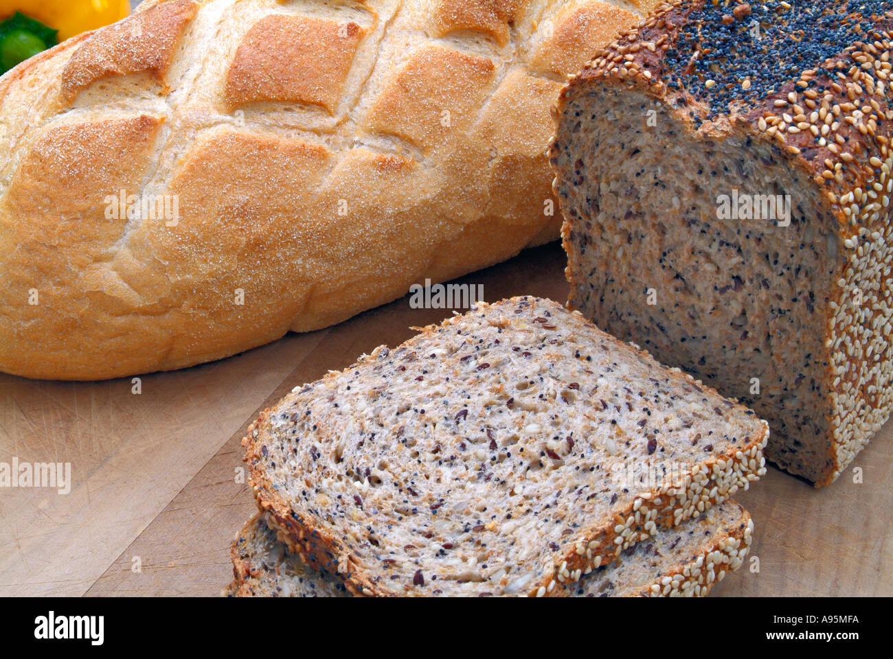 Brown bread and slices on breadboard Stock Photo - Alamy