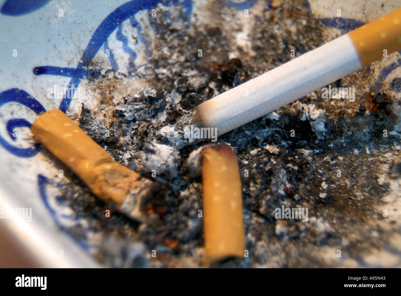 Dirty cigarette ends in ashtray Stock Photo - Alamy