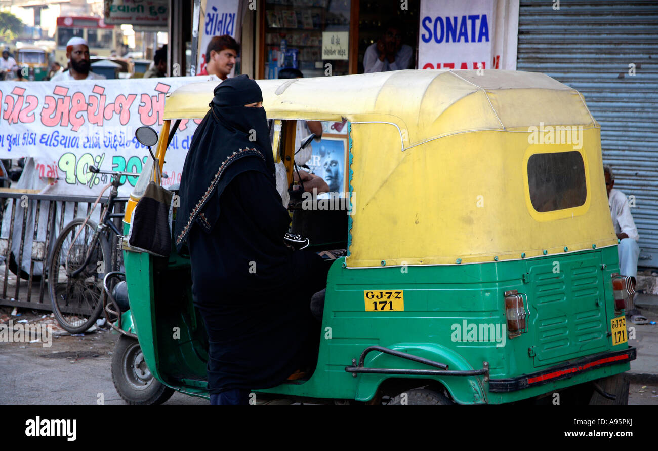 Muslim woman getting into auto rickshaw, Ahmedabad, Gujarat, India ...