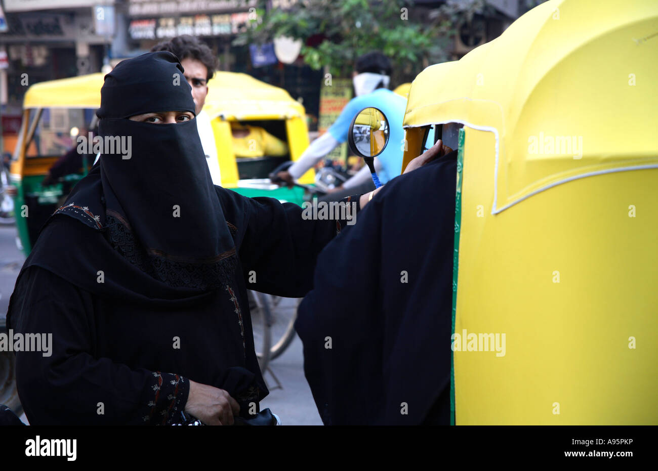 Muslim Indian woman wearing niqab getting into auto rickshaw, Ahmedabad ...