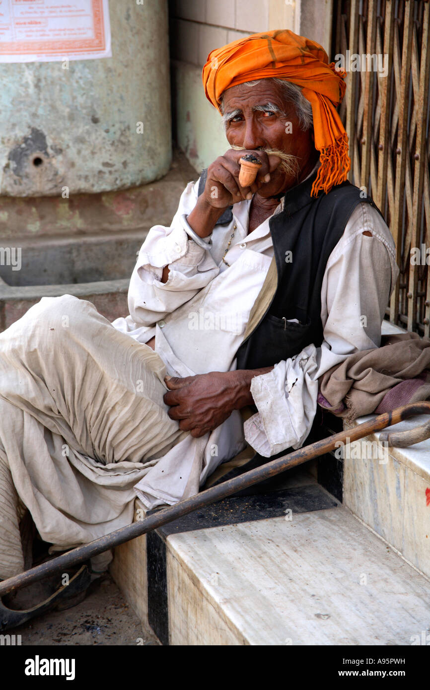 Indian Man on street step smoking pipe, Anjar, Kutch, Gujarat, India ...