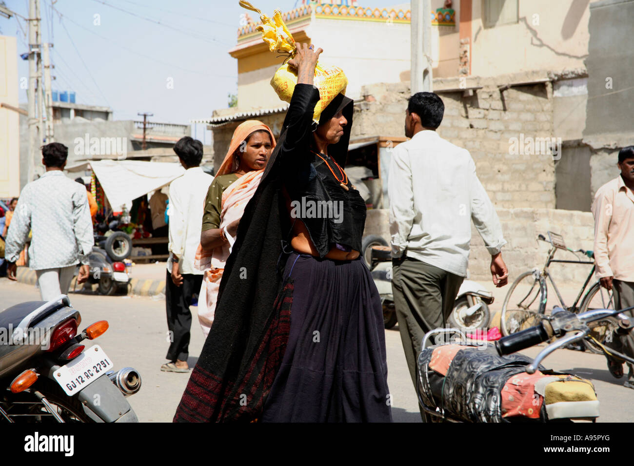 Rabari woman carrying object on head, Anjar, Kutch, Gujarat, India ...