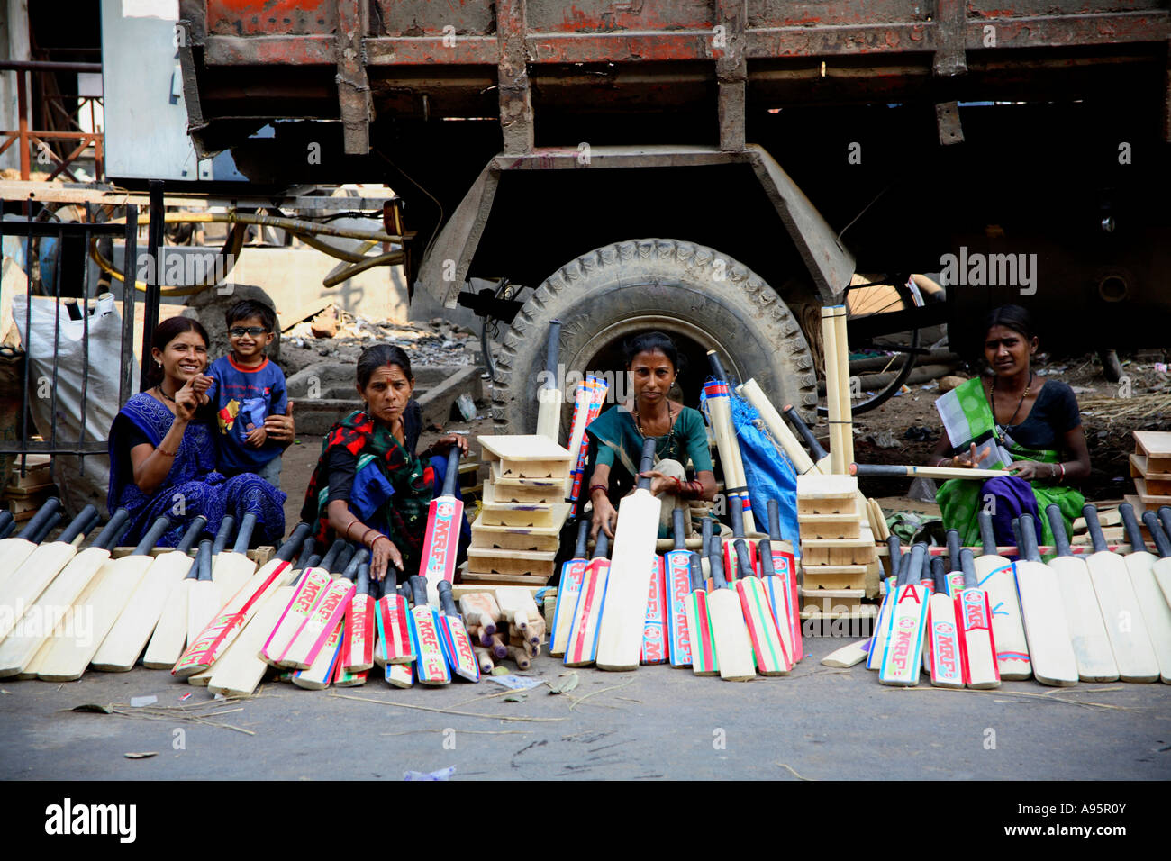 Indian women selling cricket bats at the side of the road, Vadodara ...