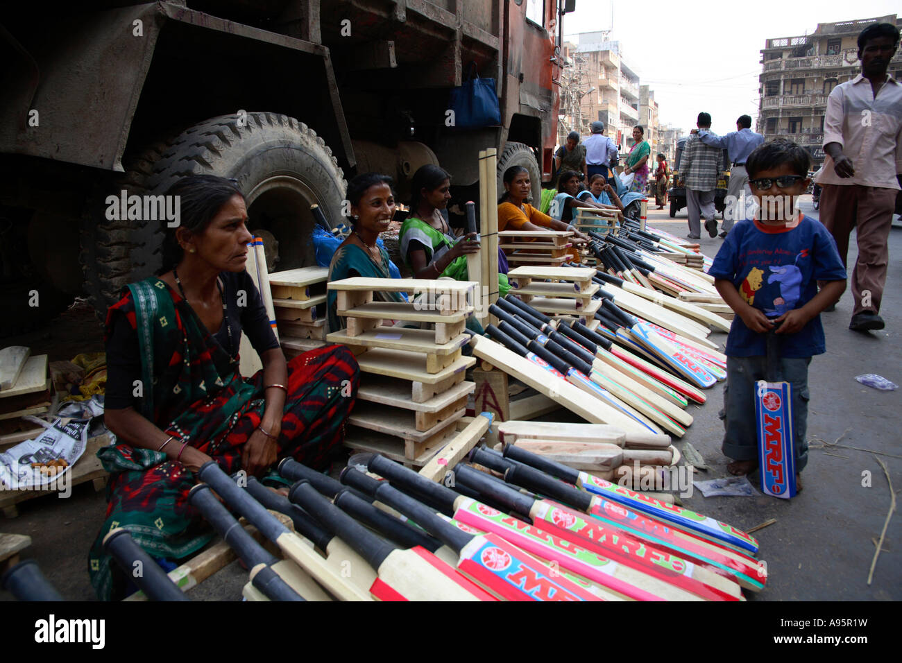 Indian women selling cricket bats at the side of the road, Vadodara ...