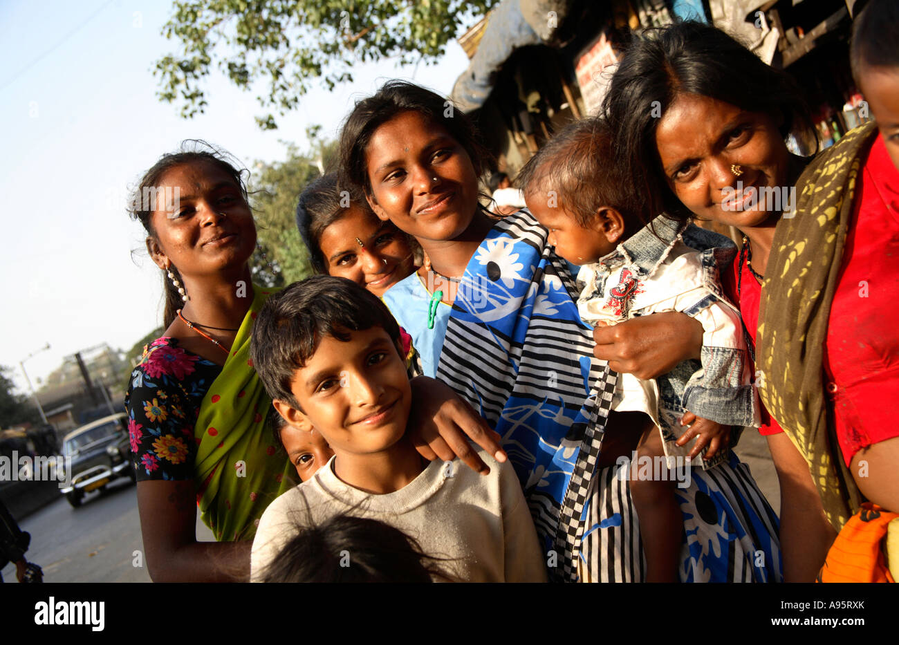 Indian families posing outside shanty housing, D'Mello Road, Mumbai ...