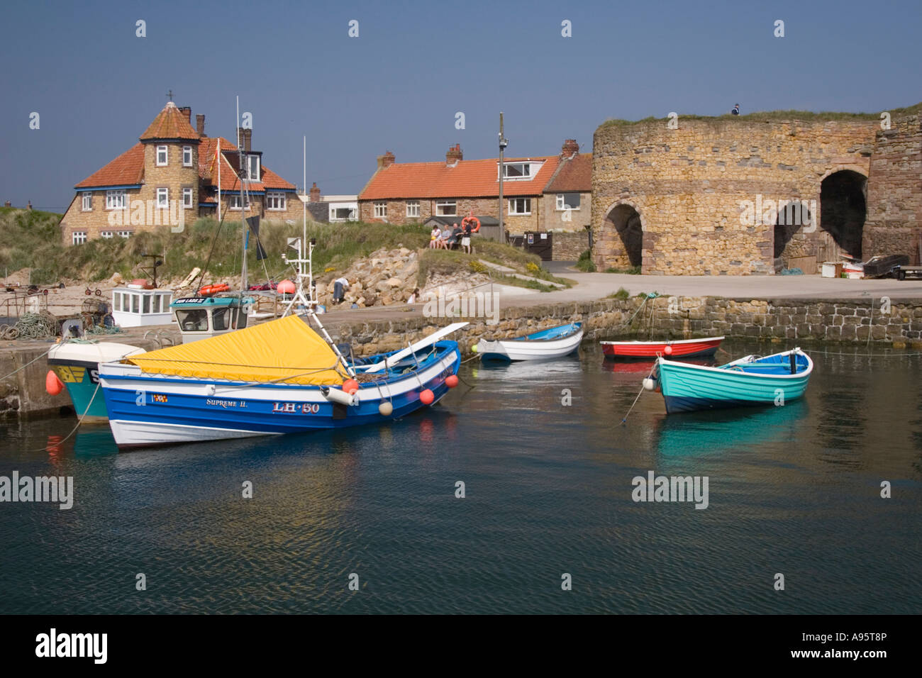 Several colorful boats in Beadnell harbour, Northumberland Stock Photo ...