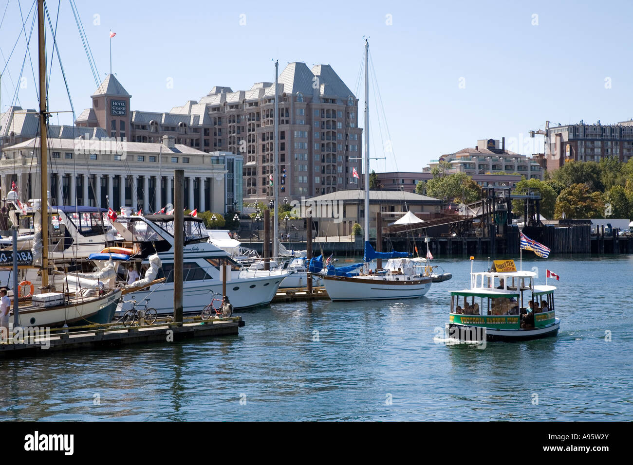 Victoria Harbour Ferry with passengers approaching moorings Victoria ...