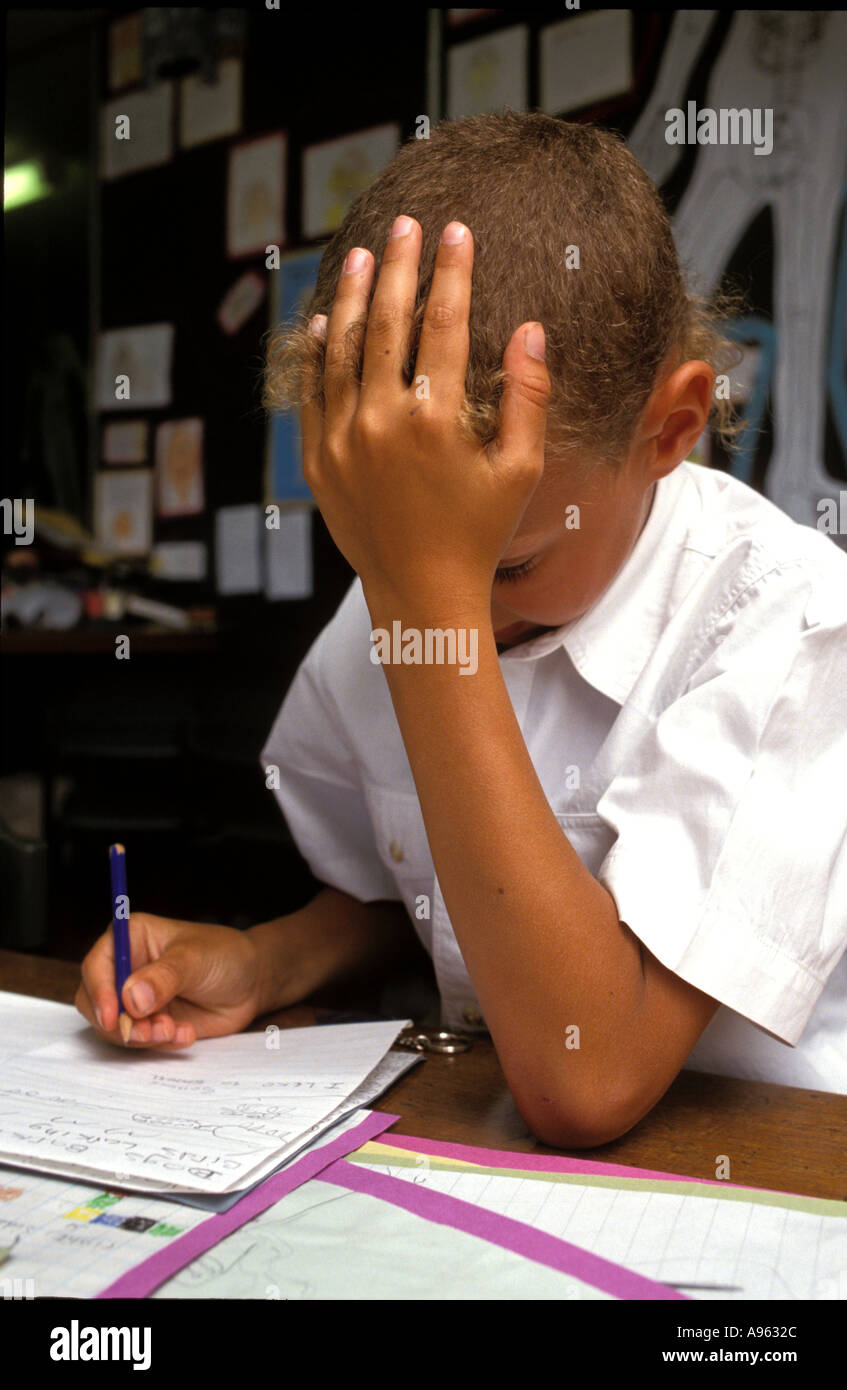 Young boy working on test paper in classroom Stock Photo - Alamy
