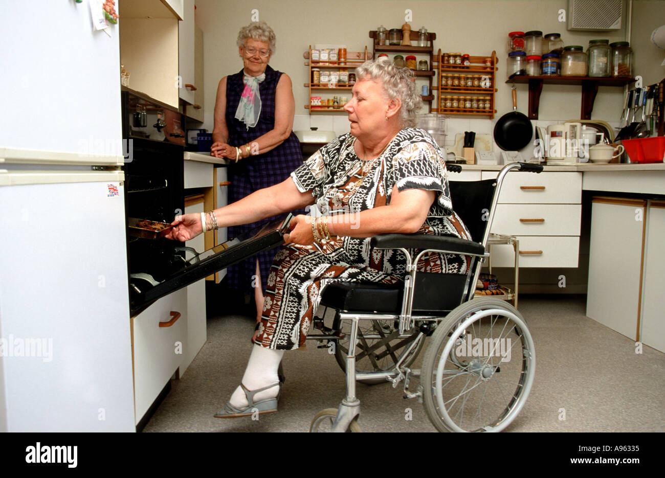 Female using wheelchair cooking hi-res stock photography and images - Alamy