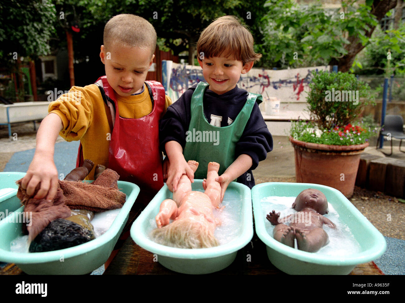 Nursery school children playing dolls hi-res stock photography and ...