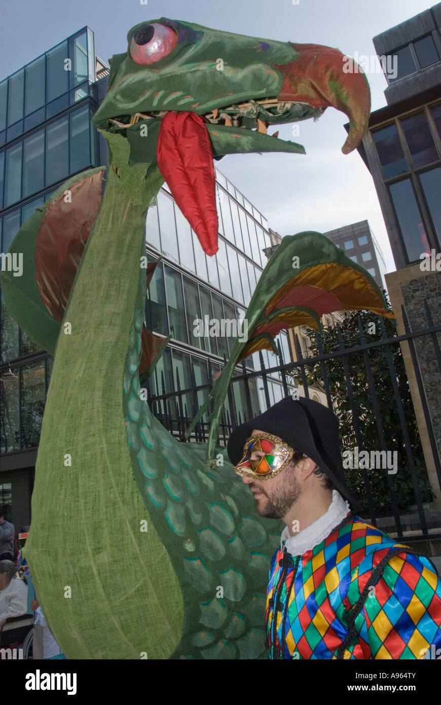 Man in Venetian mask and costume with the Dragon in procession for ...