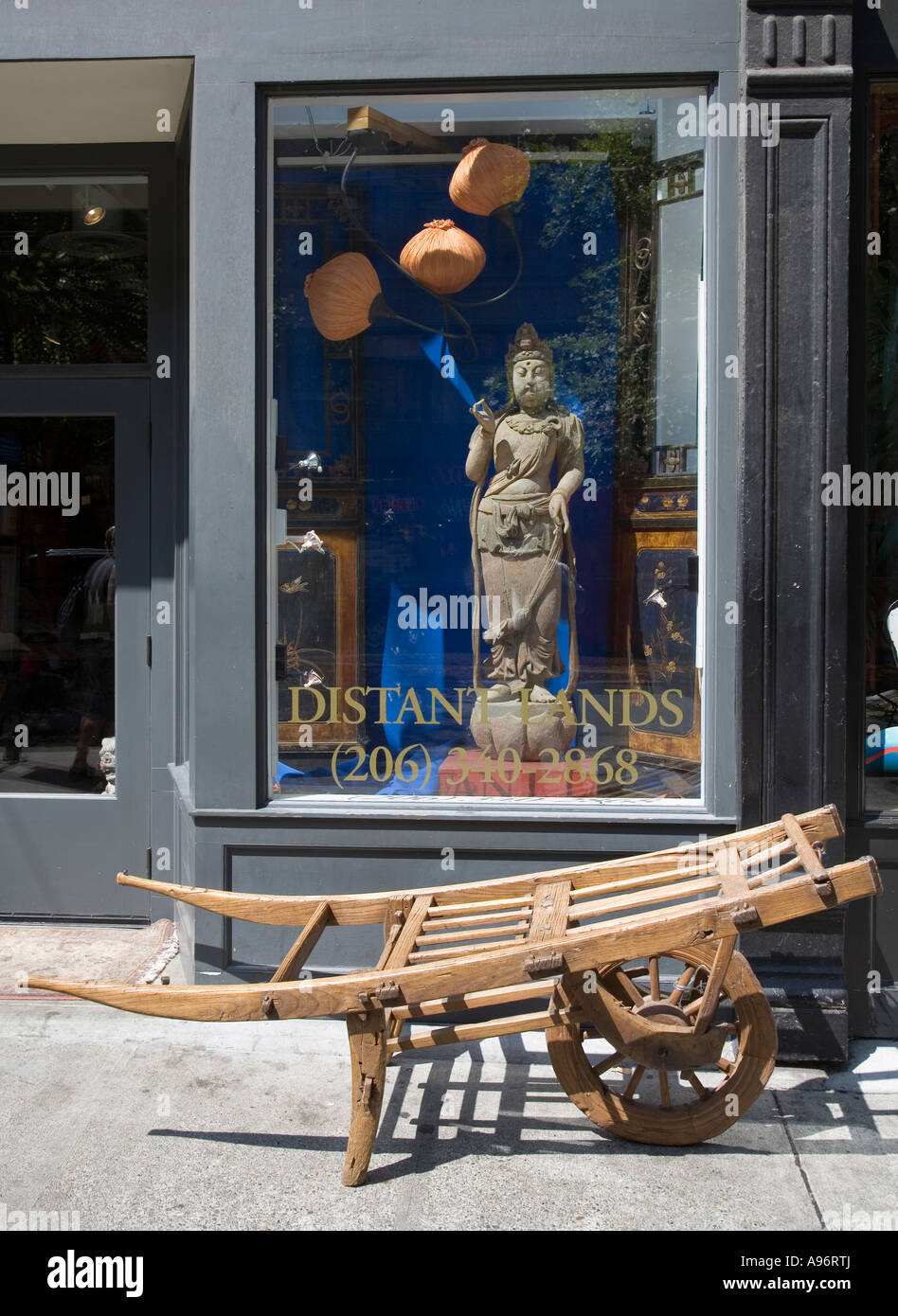Distant lands art shop window display with traditional wagon on ...
