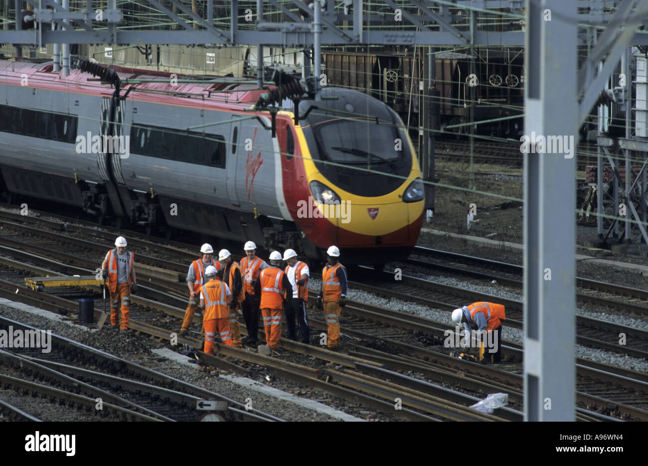 Virgin Pendolino train passing Network Rail track workers at Rugby ...