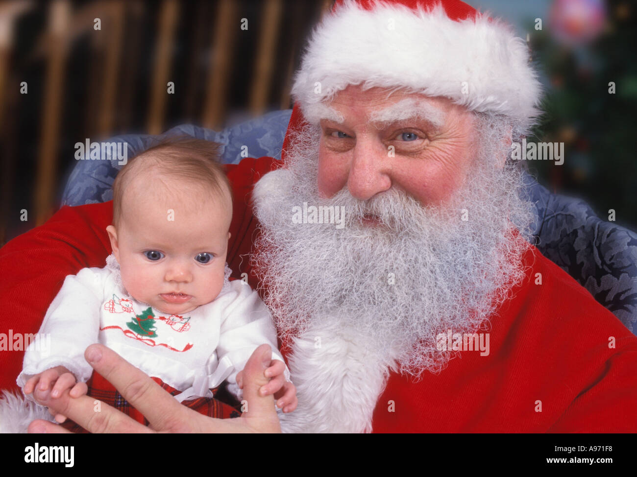 Santa Claus holds infant child Stock Photo - Alamy