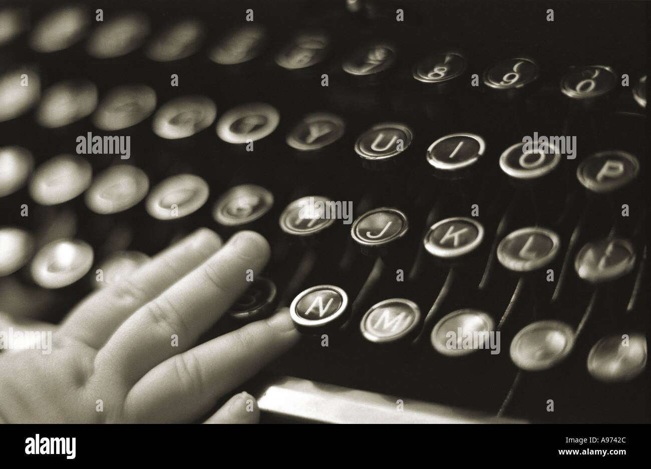 Child typing on a vintage typewriter Stock Photo - Alamy