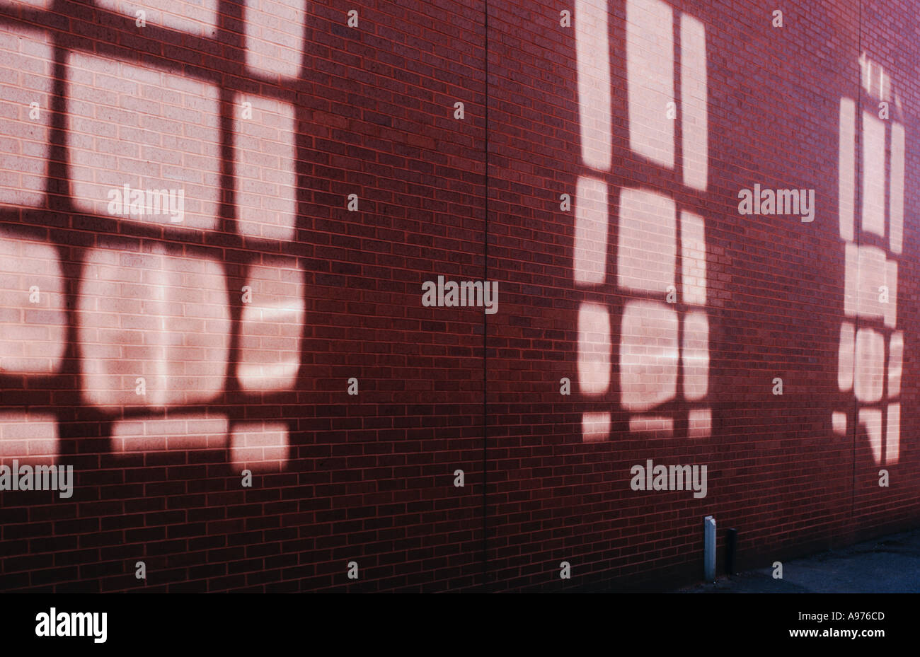 Virtual windows reflections on a red brick wall Stock Photo - Alamy