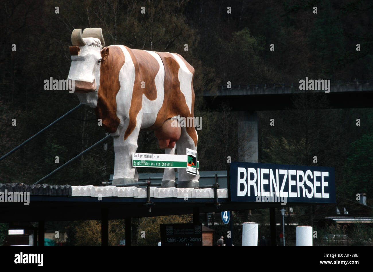 Large model of a cow above the ship dock on the Brienzersee lake in ...