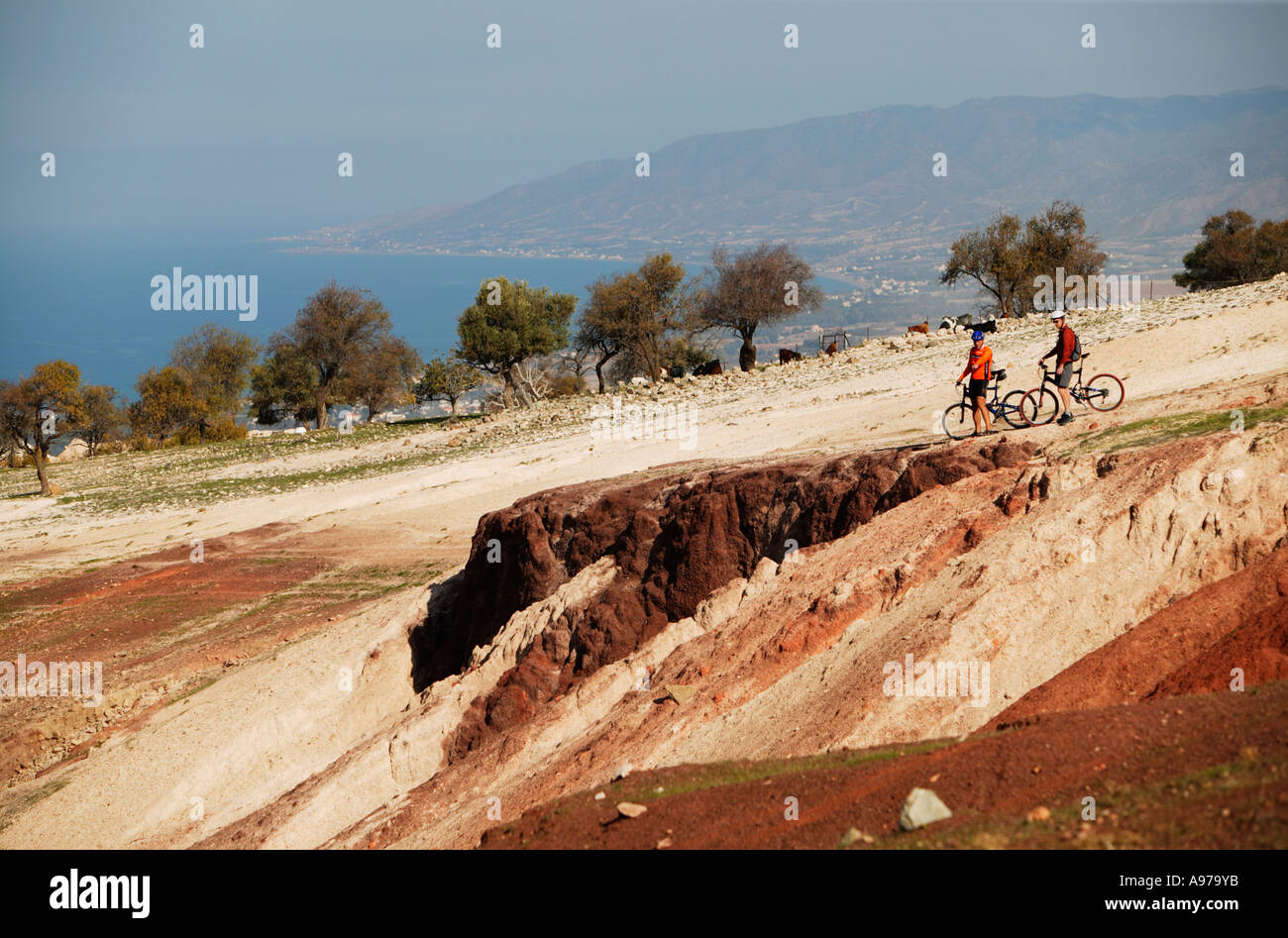 Mountain bike riders at an unusual earth formation in Cyprus Stock ...