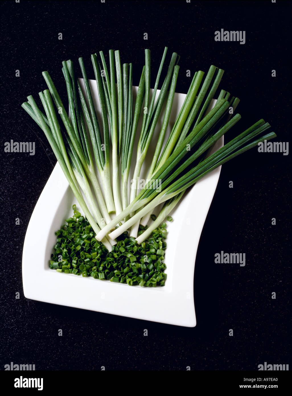 Agriculture - Whole and chopped fresh green onions (scallions) arranged ...