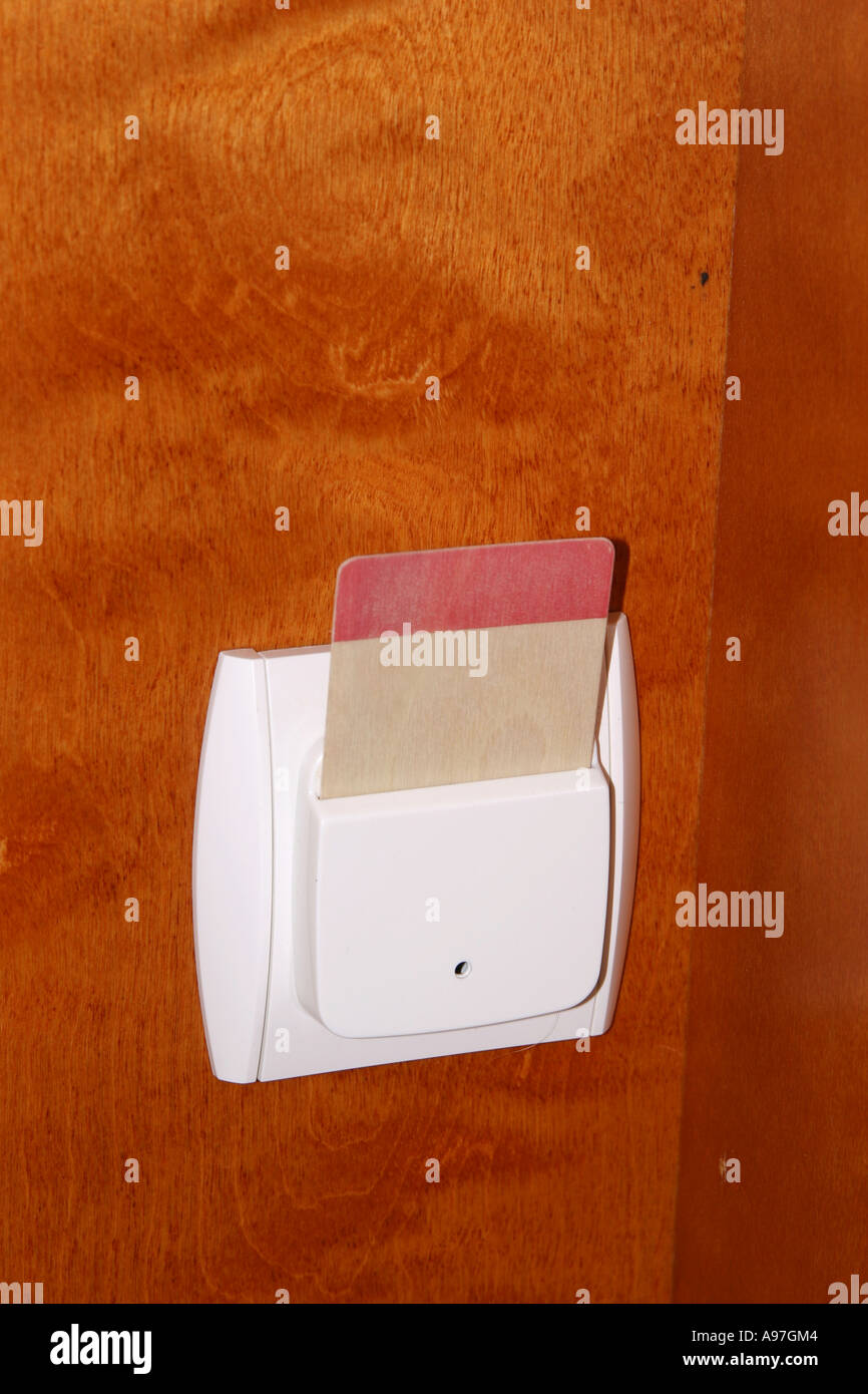 Room key holder in a hotel room which also works as the main power on ...