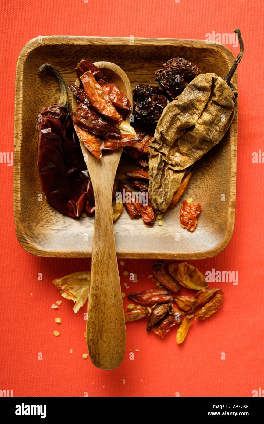 Various dried chili peppers in wooden bowl FoodCollection Stock Photo ...