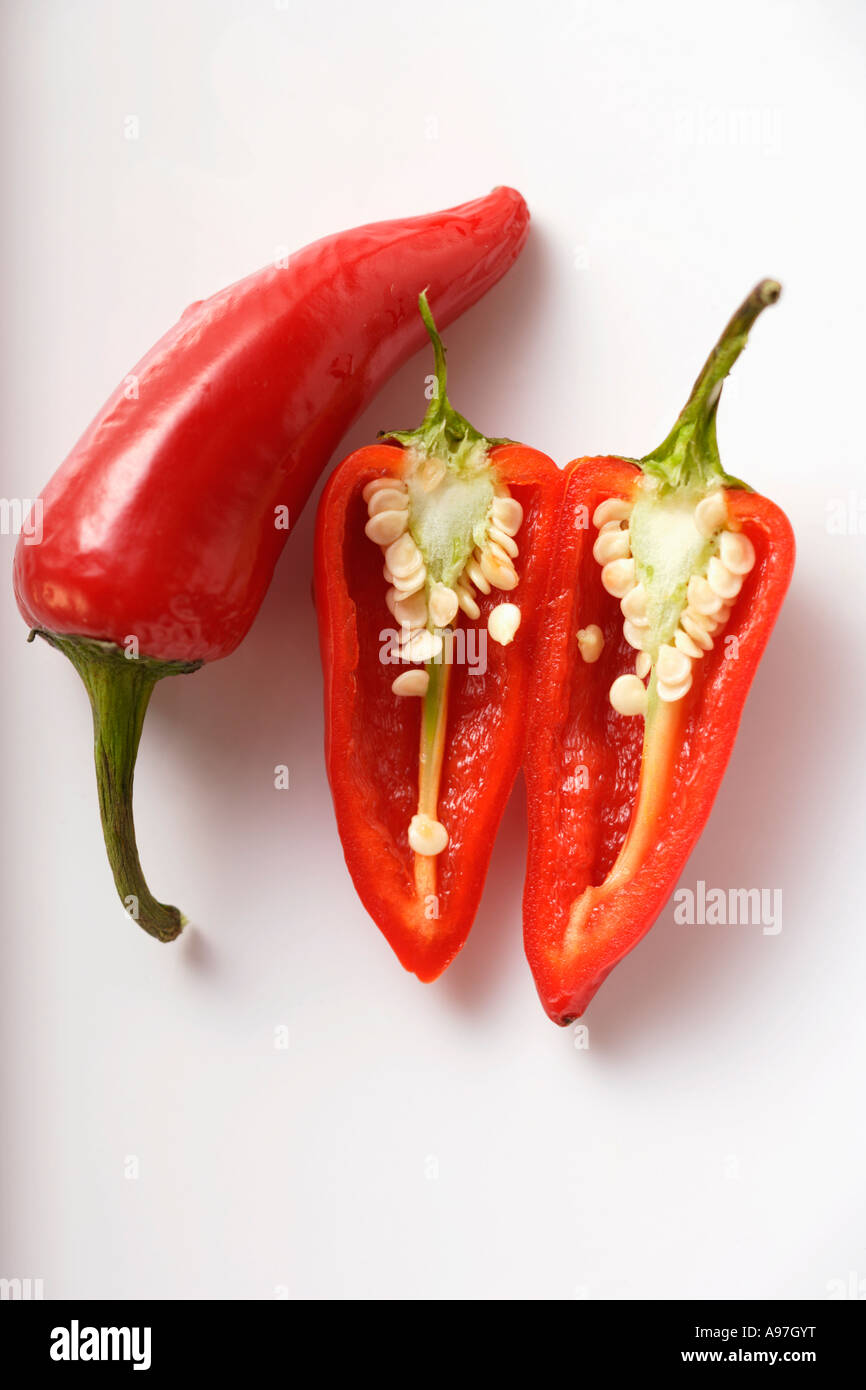 Two red chili peppers one halved FoodCollection Stock Photo - Alamy