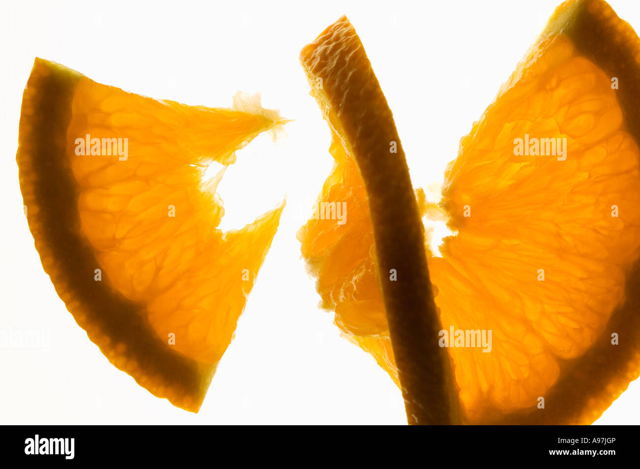 Slice of orange cut into two pieces backlit FoodCollection Stock Photo ...