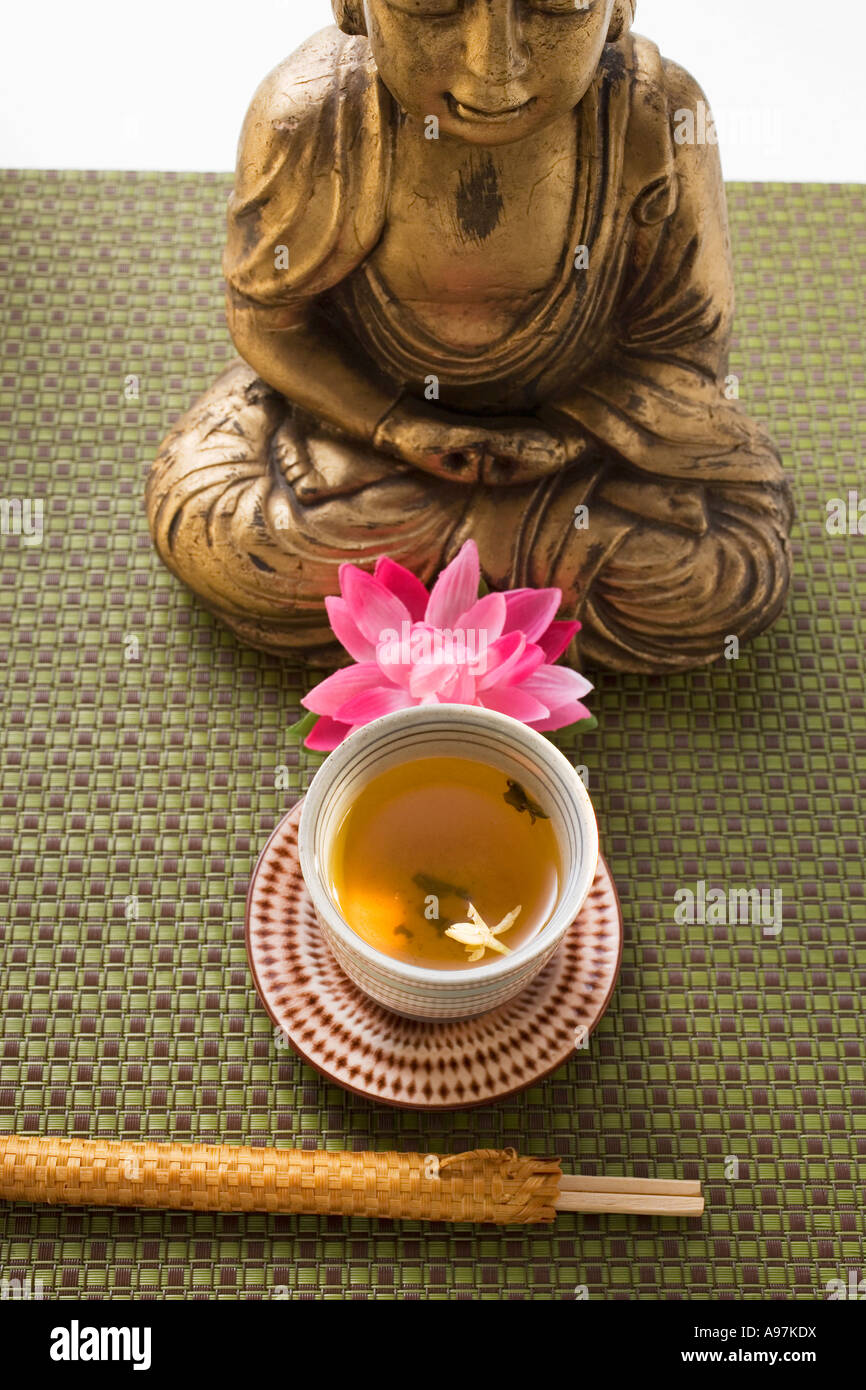 Jasmine tea in small bowl in front of Buddha FoodCollection Stock Photo ...