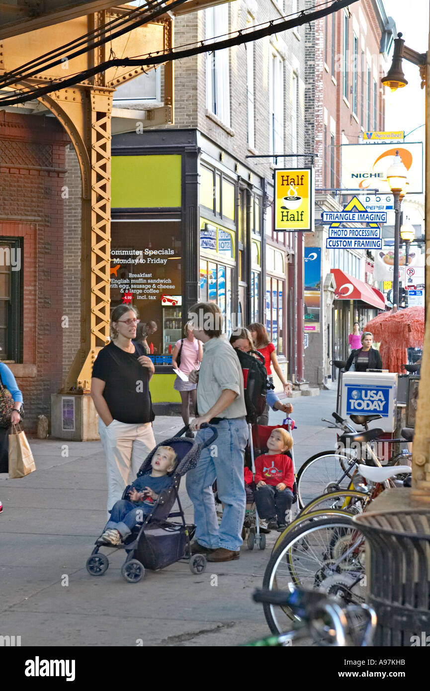 ILLINOIS Chicago Man and woman parents with strollers on sidewalk under ...