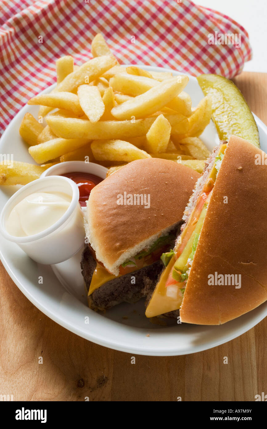 Cheeseburger chips mayonnaise ketchup on plate FoodCollection Stock ...