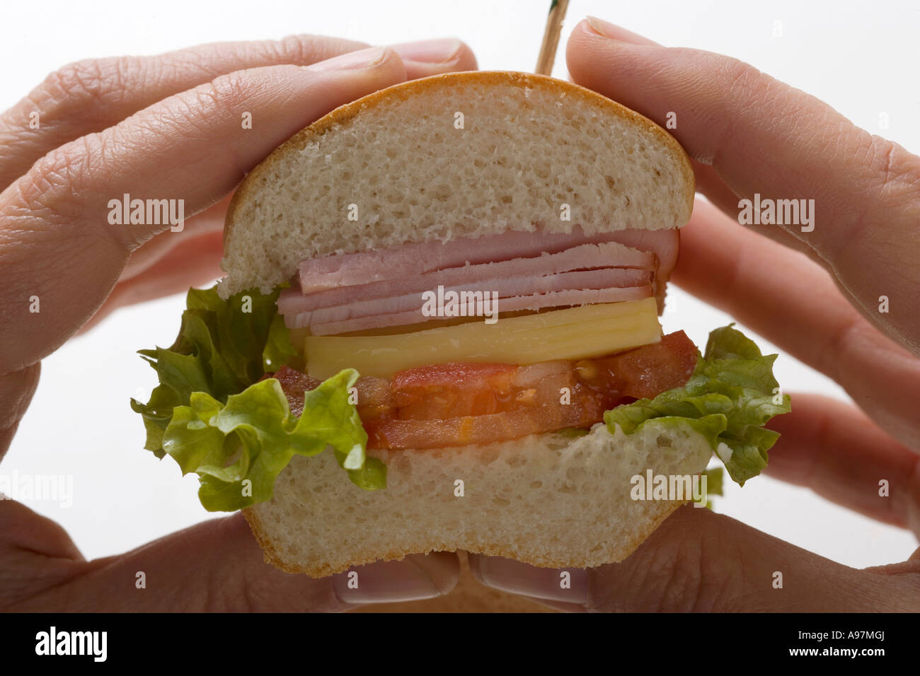 Hands holding ham and cheese sub sandwich FoodCollection Stock Photo ...