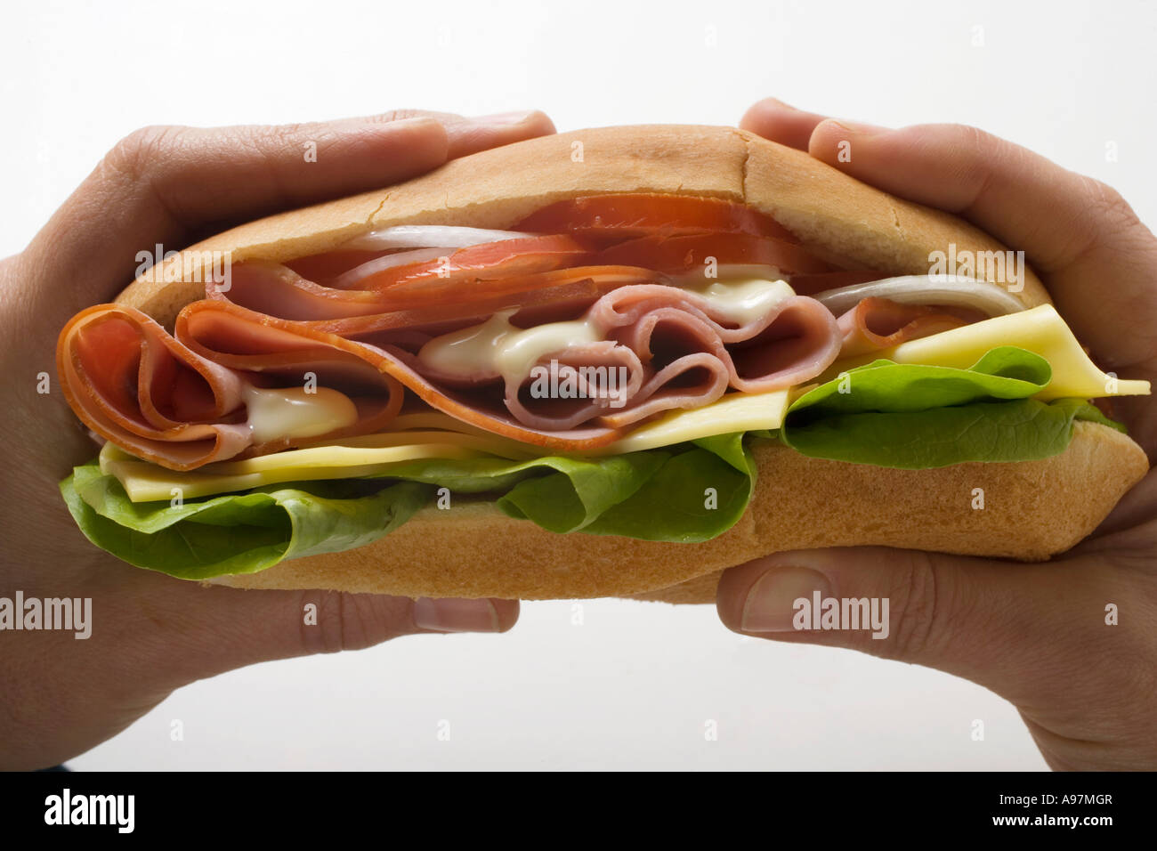 Hands holding ham and cheese sub sandwich FoodCollection Stock Photo ...